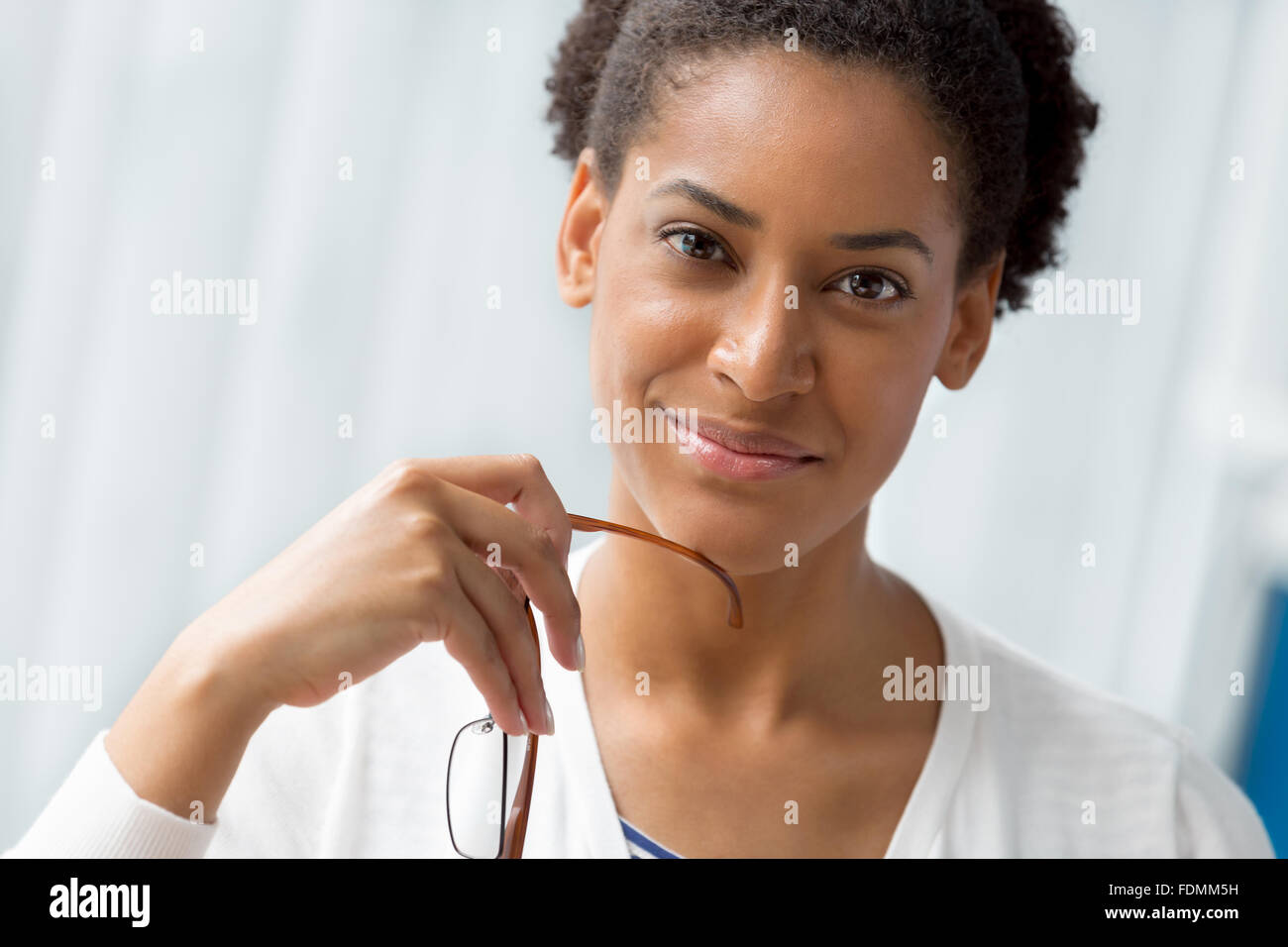 Businesswoman smiling and sitting in offfice Stock Photo - Alamy