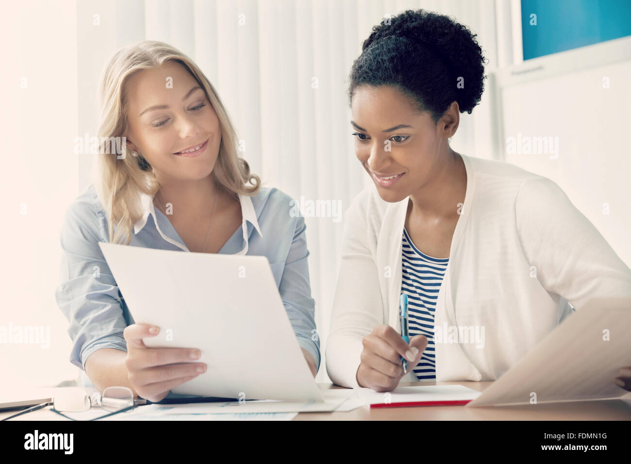 Two women working together in office Stock Photo - Alamy