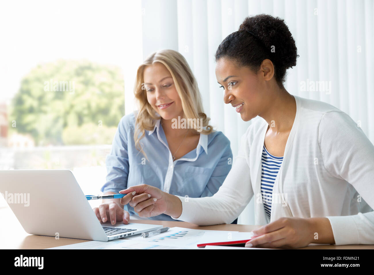 Two women working together in office Stock Photo - Alamy