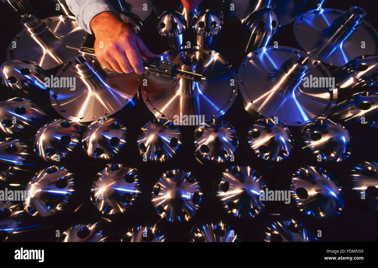 An engineer with a micrometer measures tolerance of precision made ...