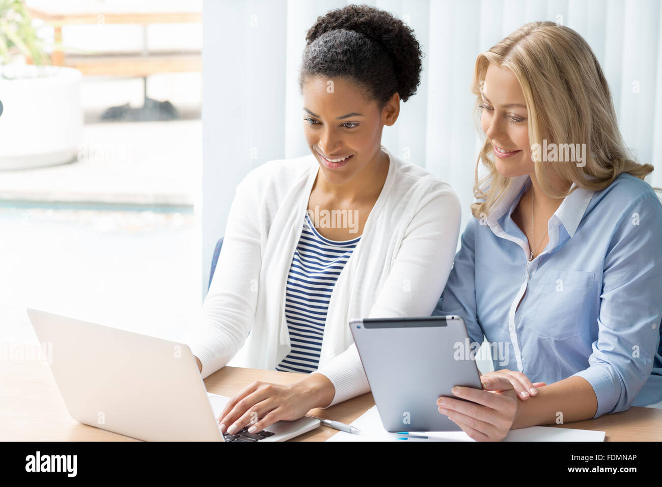 Two women working together in office Stock Photo - Alamy