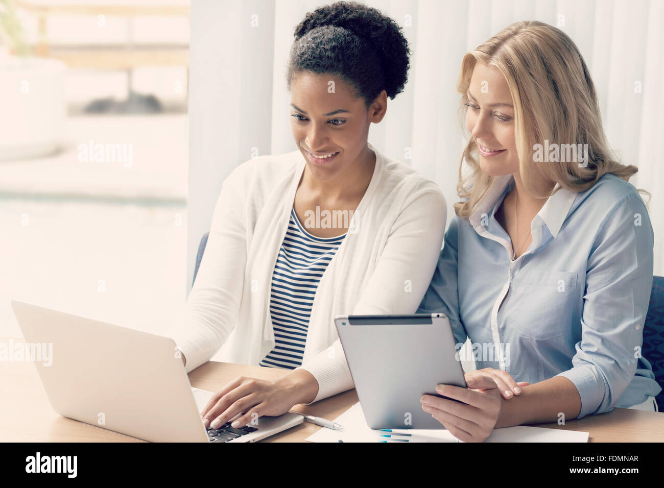 Two women working together in office Stock Photo - Alamy