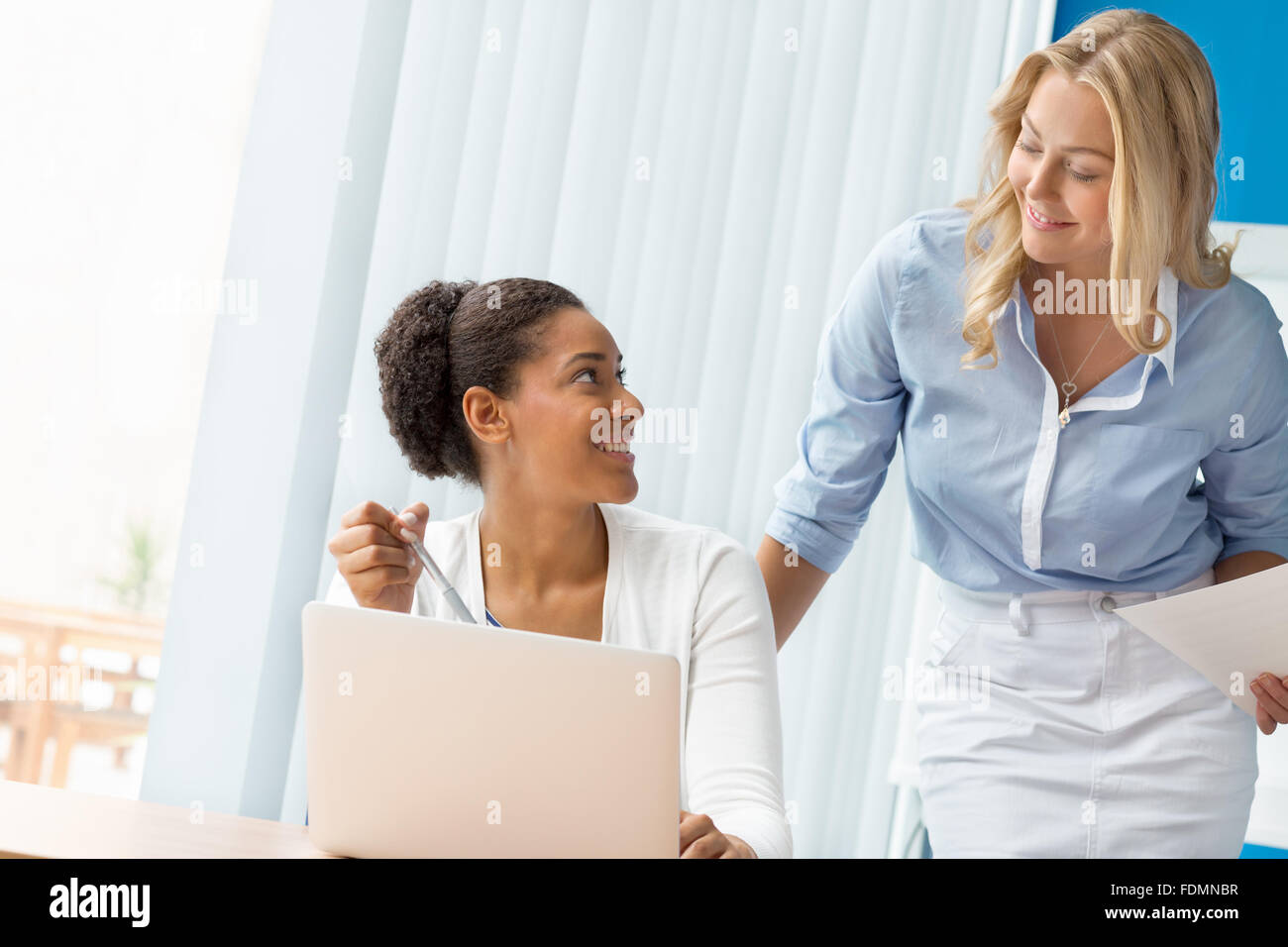 Two women working together in office Stock Photo - Alamy