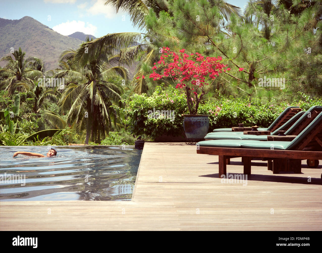 A woman swimming in the infinity pool at The Farm at San Benito ...