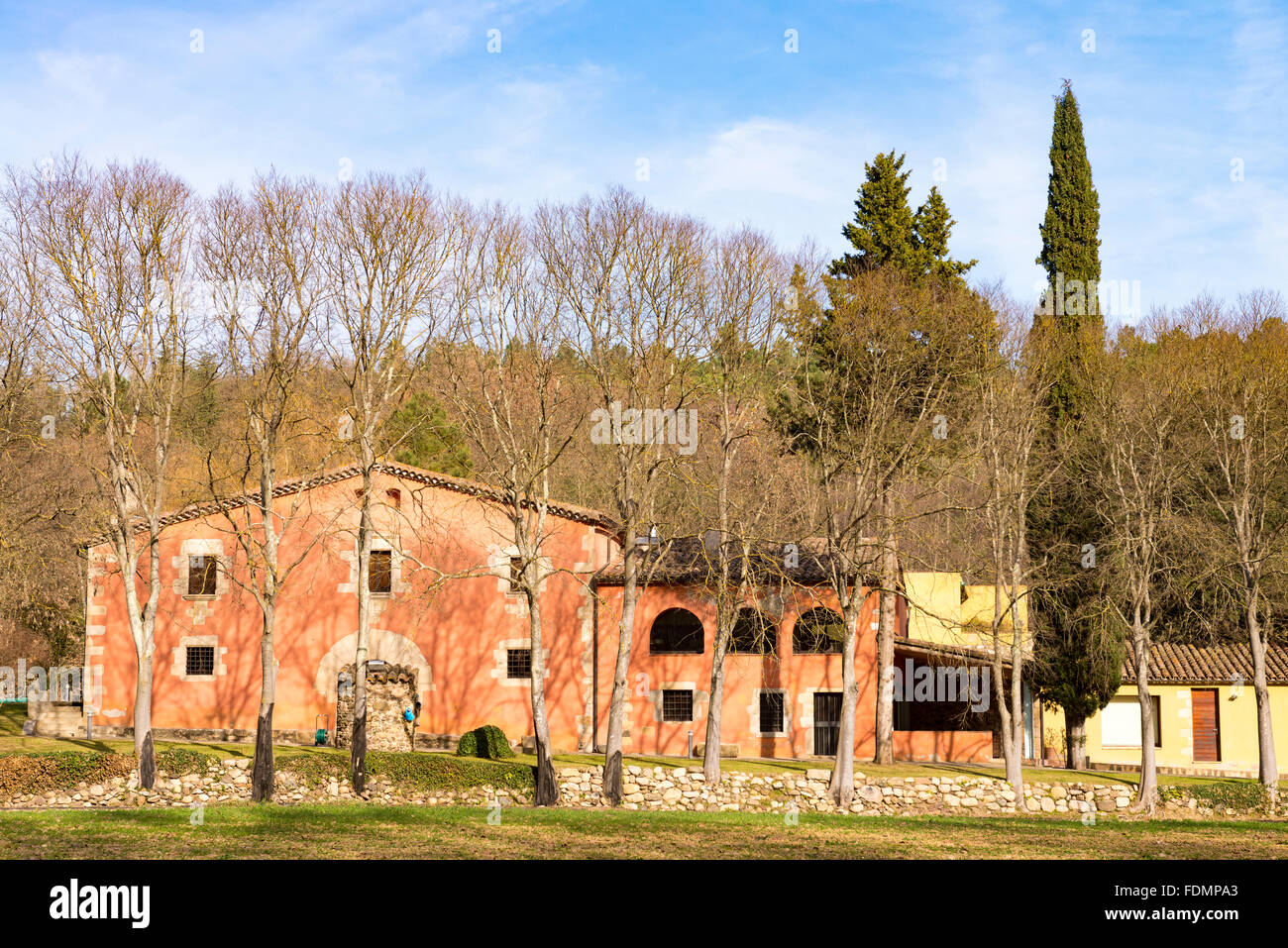 A red Spanish farm house with trees all around Stock Photo - Alamy