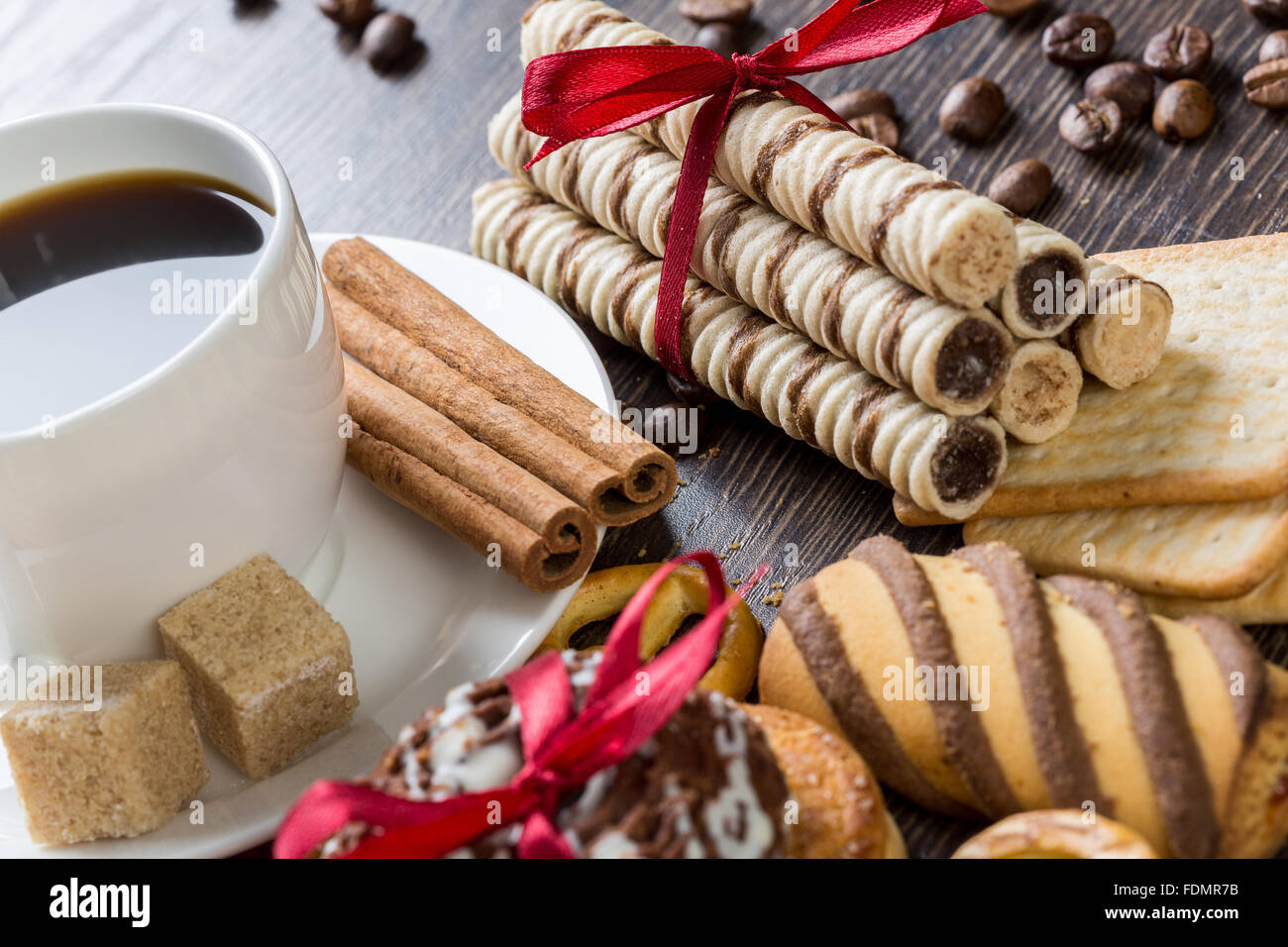 Assorted biscuits and sweets with a cup of coffee on table Stock Photo ...