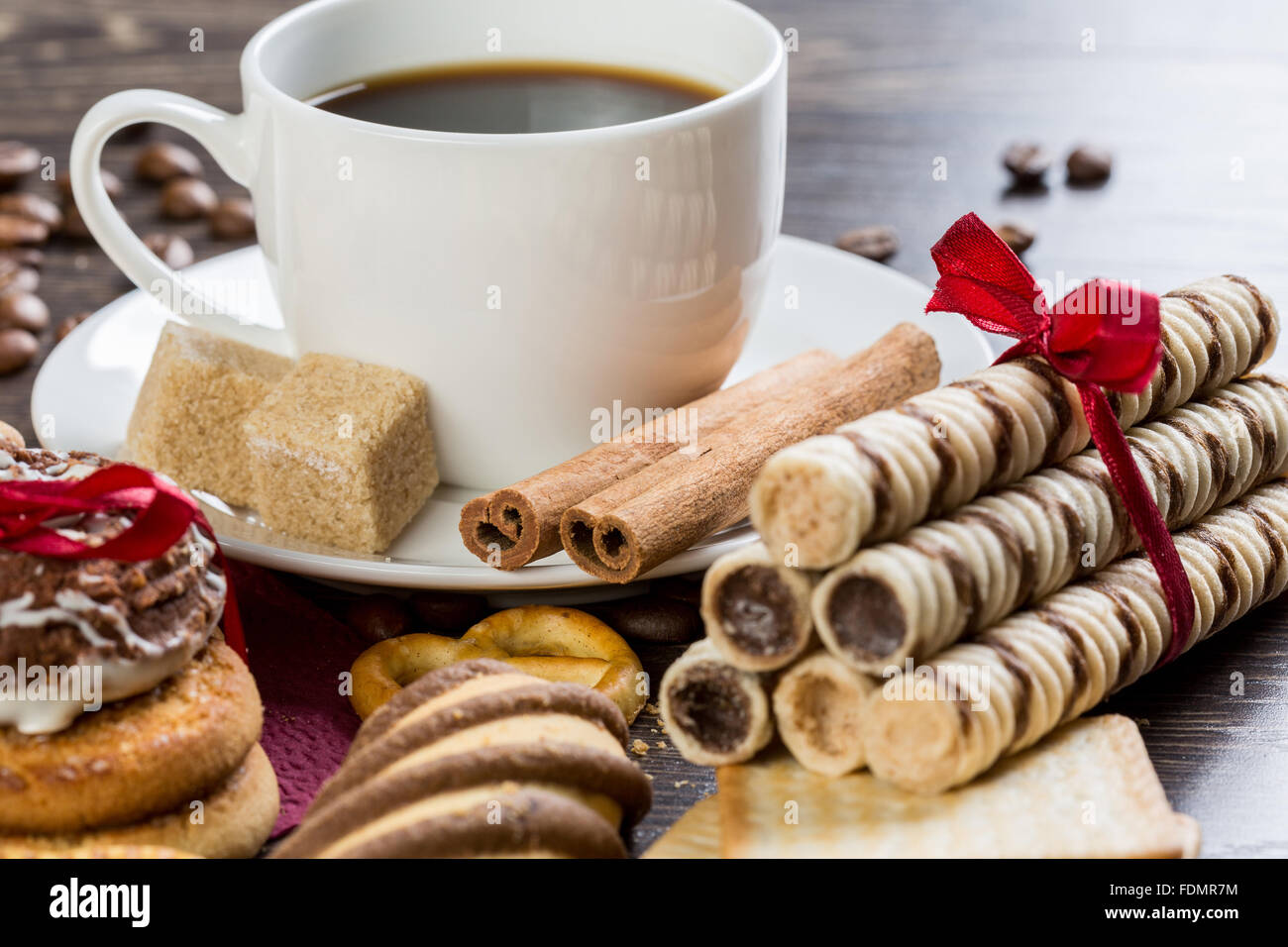 Assorted biscuits and sweets with a cup of coffee on table Stock Photo ...