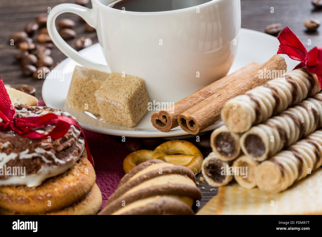 Assorted biscuits and sweets with a cup of coffee on table Stock Photo ...