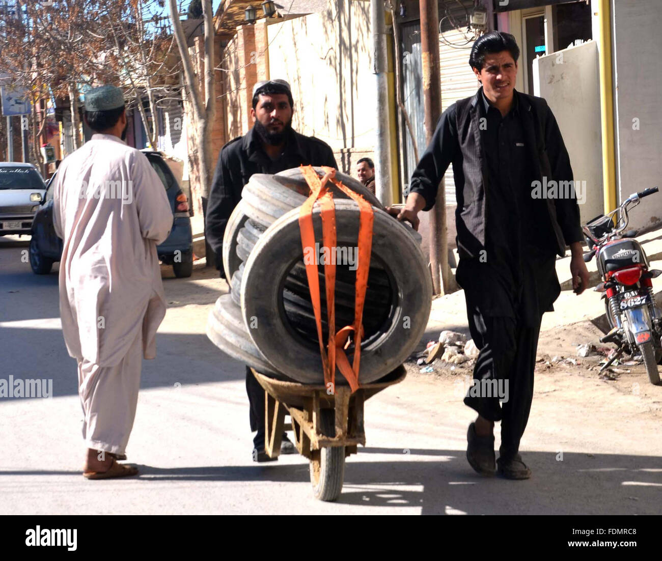 Karachi, Pakistan. 1st February, 2016. Laborers carrying tyres loaded ...