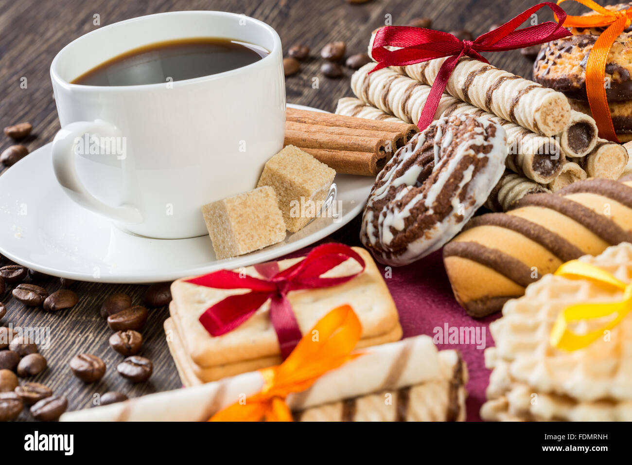 Assorted biscuits and sweets with a cup of coffee on table Stock Photo ...