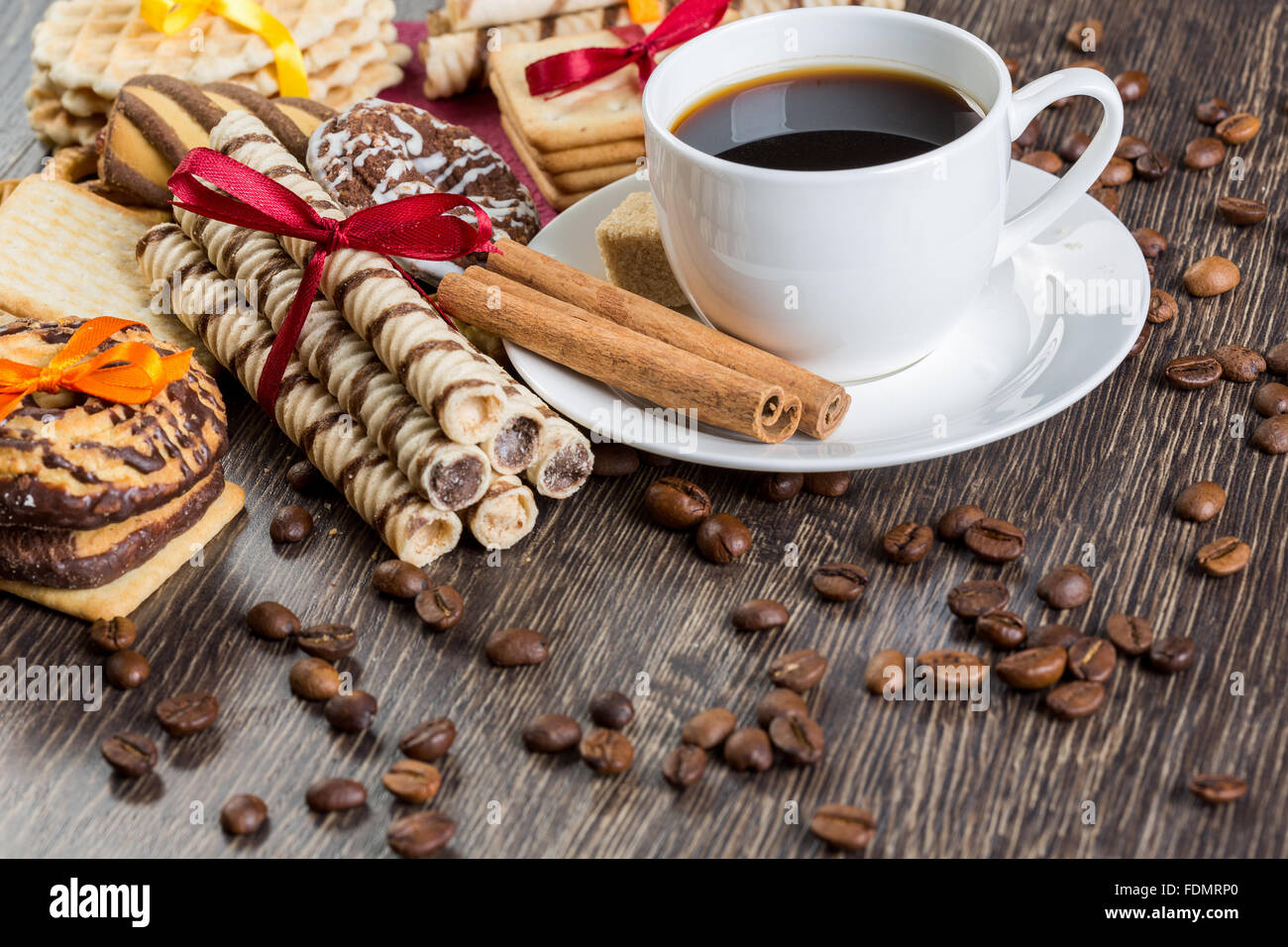 Assorted biscuits and sweets with a cup of coffee on table Stock Photo ...