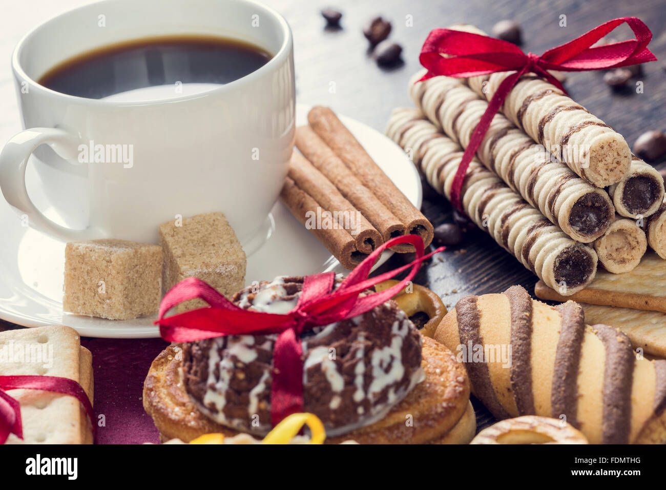 Assorted biscuits and sweets with a cup of coffee on table Stock Photo ...