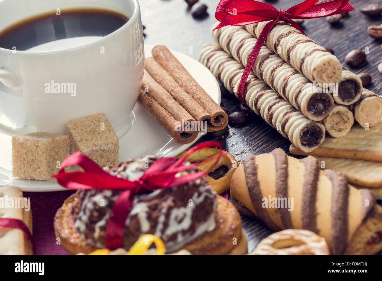 Assorted biscuits and sweets with a cup of coffee on table Stock Photo ...