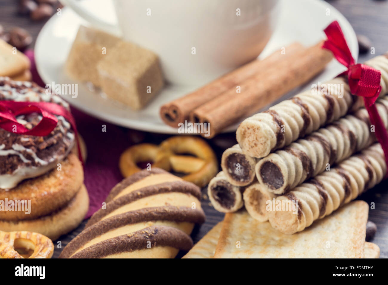 Assorted biscuits and sweets with a cup of coffee on table Stock Photo ...