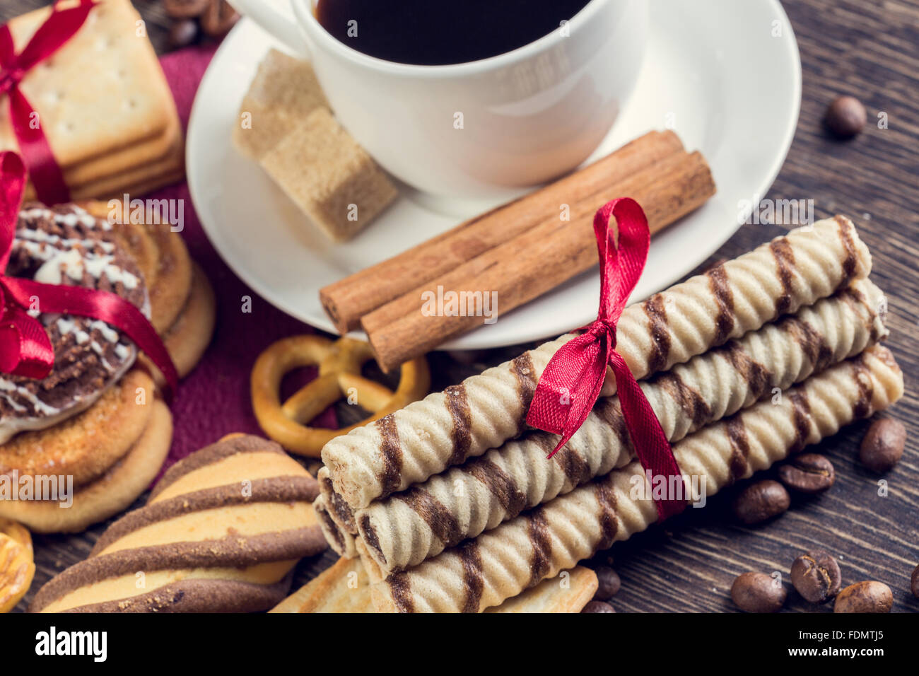 Assorted biscuits and sweets with a cup of coffee on table Stock Photo ...