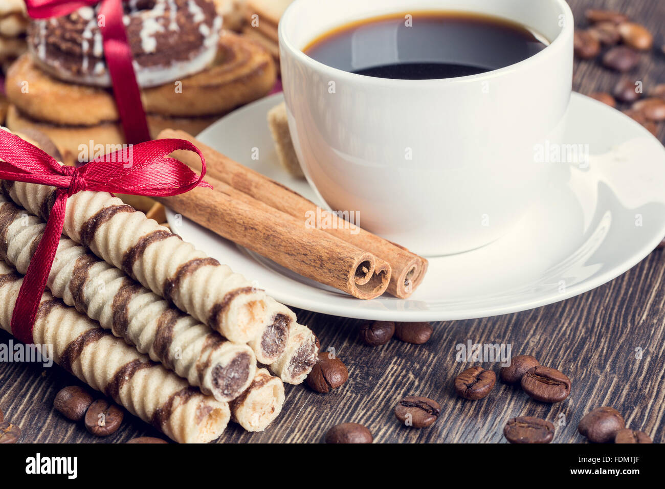 Assorted biscuits and sweets with a cup of coffee on table Stock Photo ...
