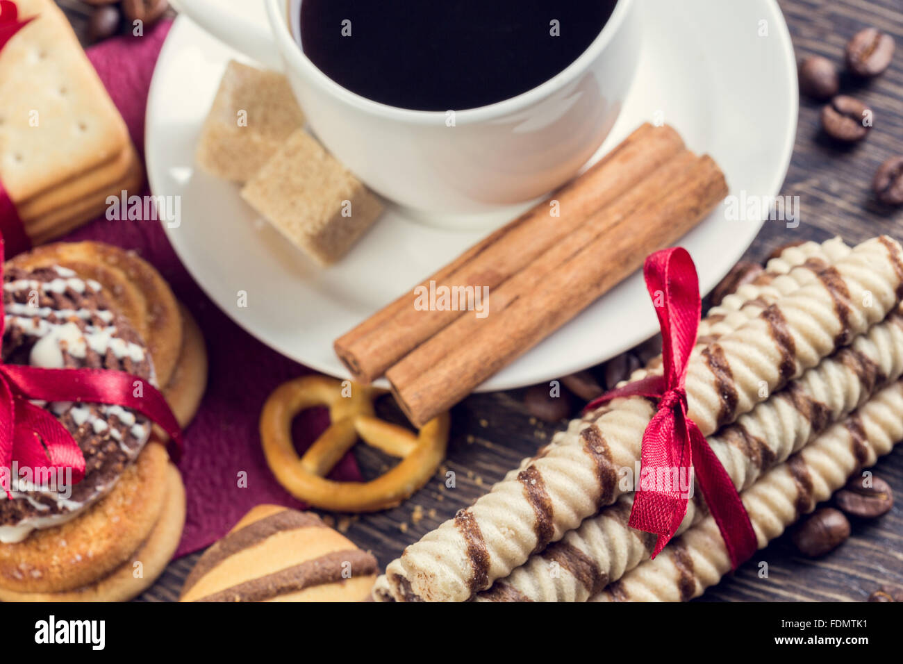 Assorted biscuits and sweets with a cup of coffee on table Stock Photo ...