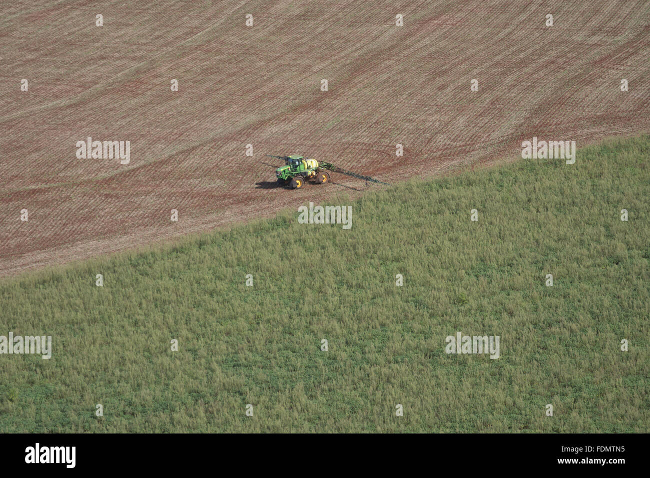 Aerial view of agricultural spraying machine the land for corn planting ...