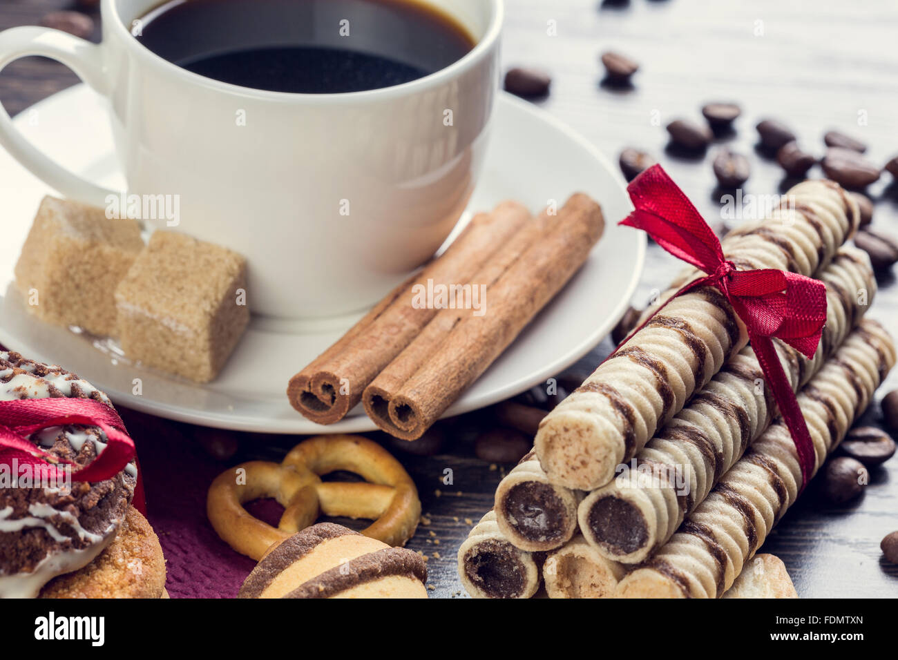 Assorted biscuits and sweets with a cup of coffee on table Stock Photo ...