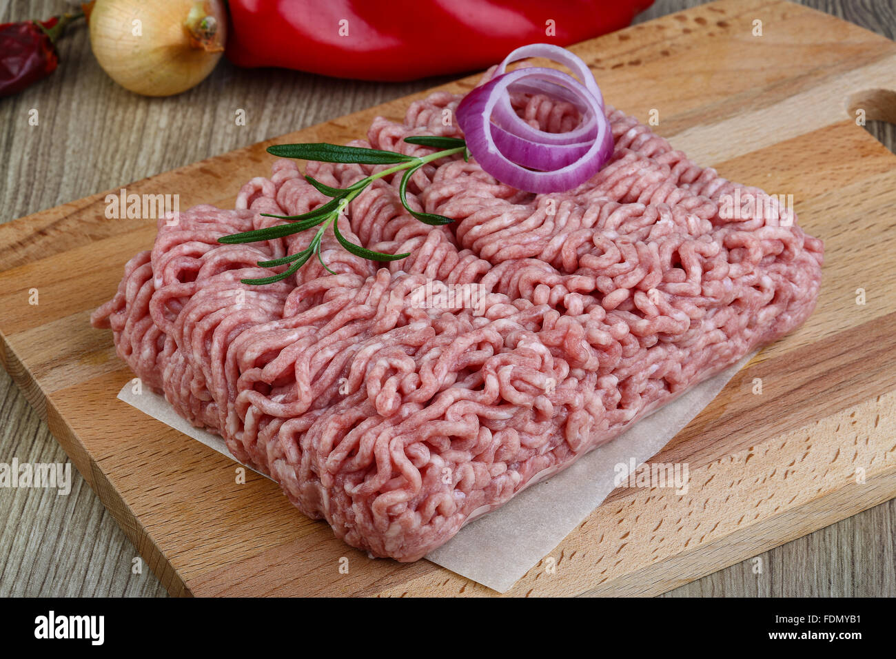 Raw minced pork meat with onion and rosemary ready for cooking Stock ...