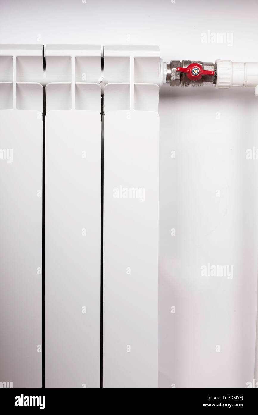 White radiator convector in an apartment faucet valve Stock Photo - Alamy