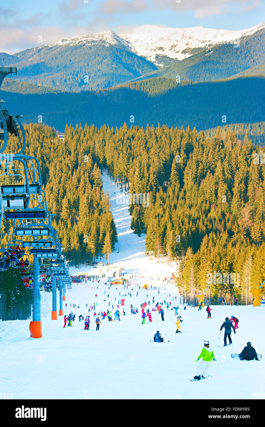 People skiing and snowboarding on a slope at ski resort Stock Photo - Alamy