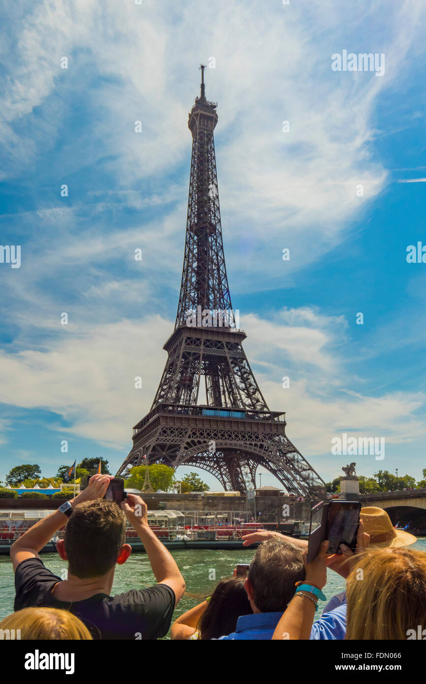 Tourist photographing Eiffel Tower from river cruise boat on Seine ...