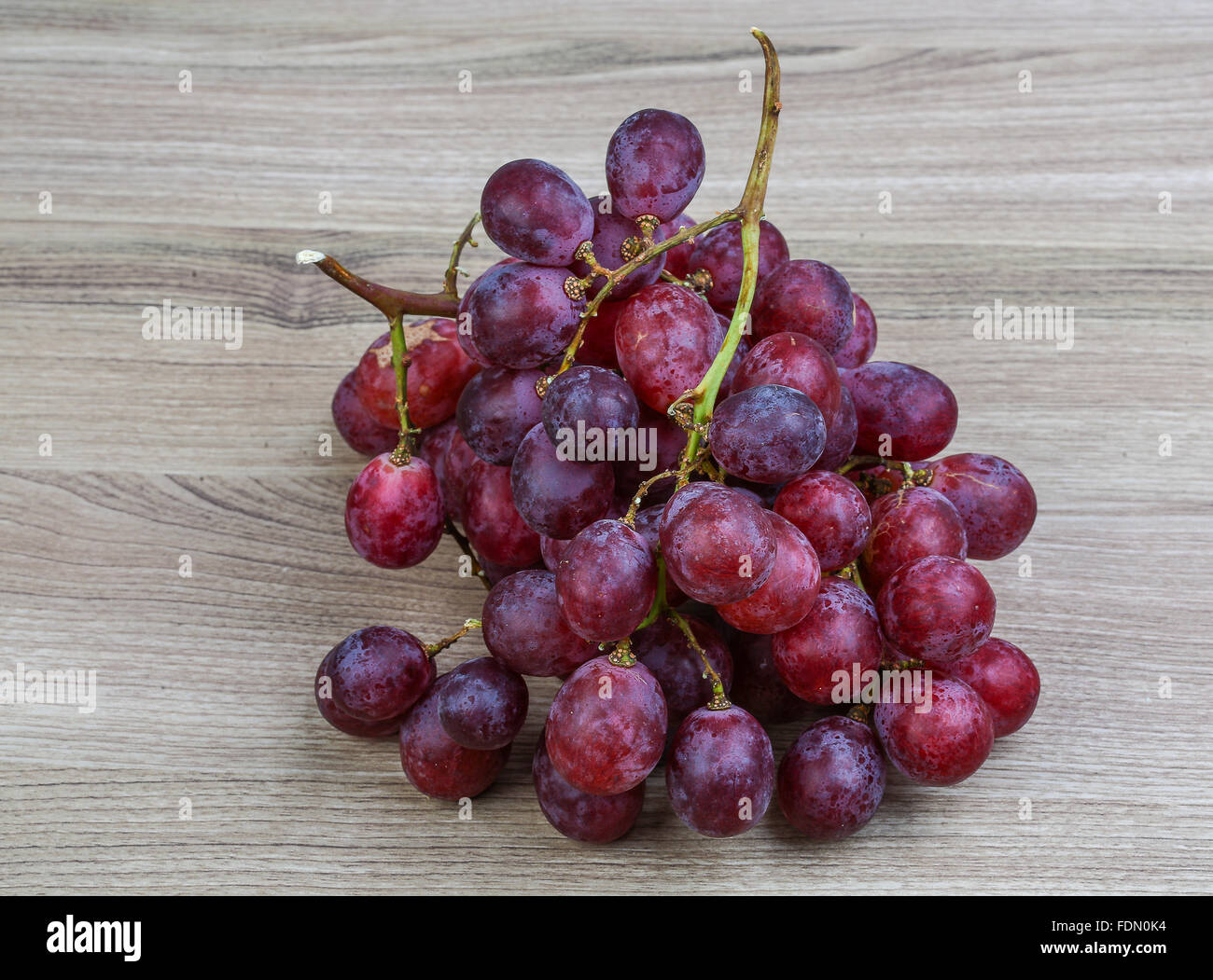 Fresh bright Grape branch on the wood background Stock Photo - Alamy