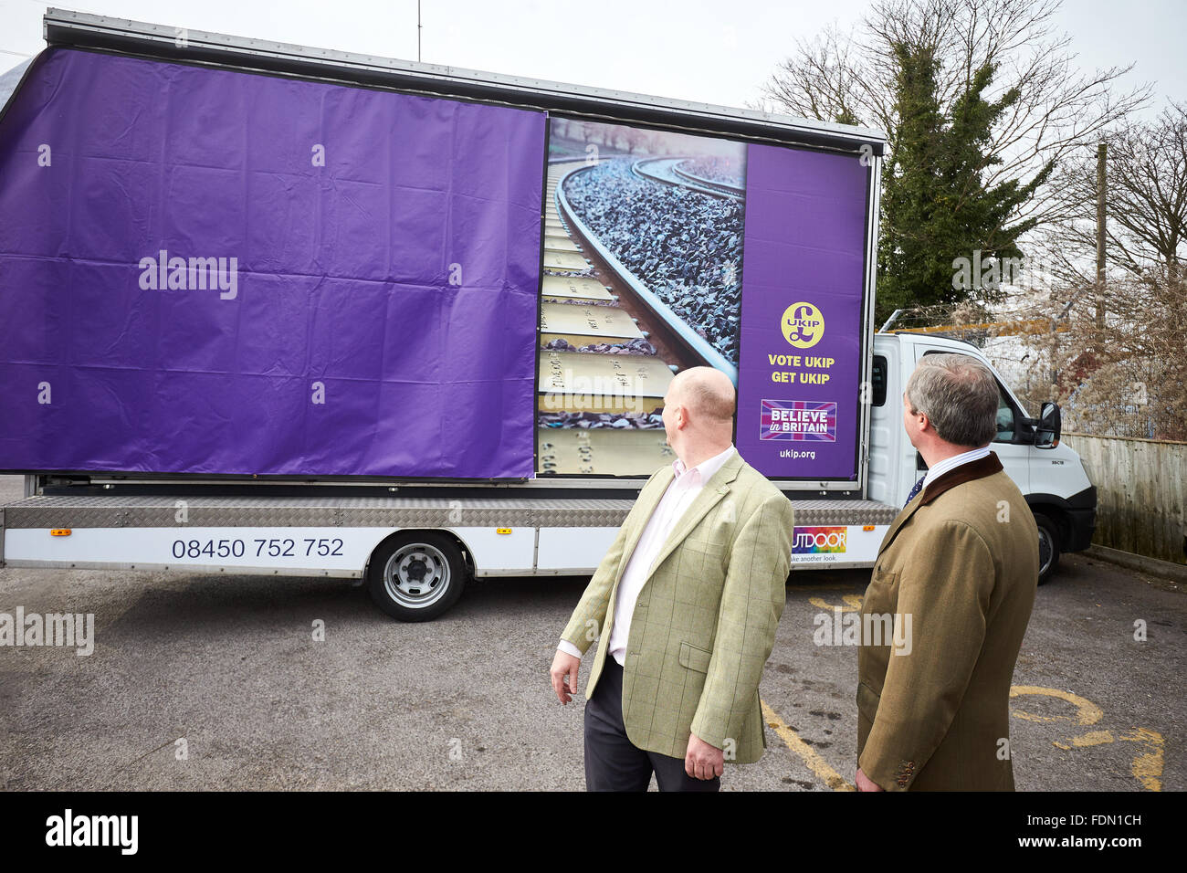 UKIP party leader Nigel Farage (R) unveils a new anti-HS2 poster at ...