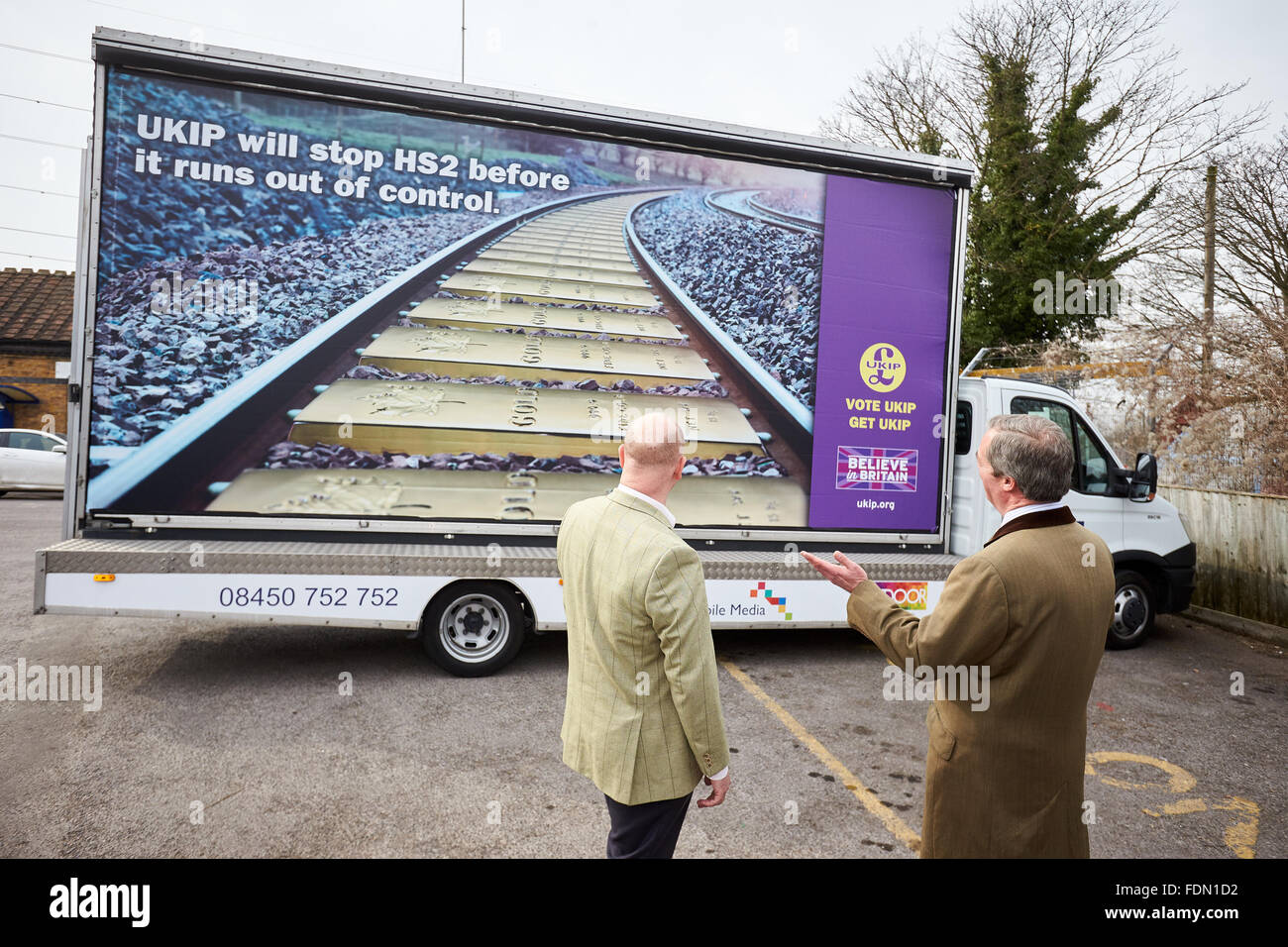 UKIP party leader Nigel Farage (R) unveils a new anti-HS2 poster at ...