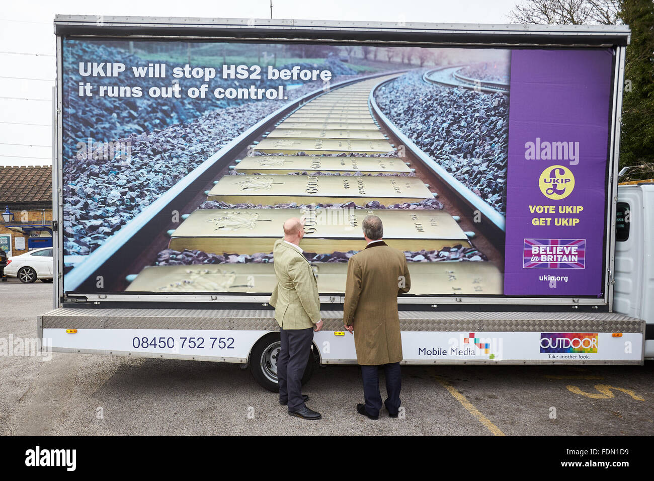 UKIP party leader Nigel Farage (R) unveils a new anti-HS2 poster at ...