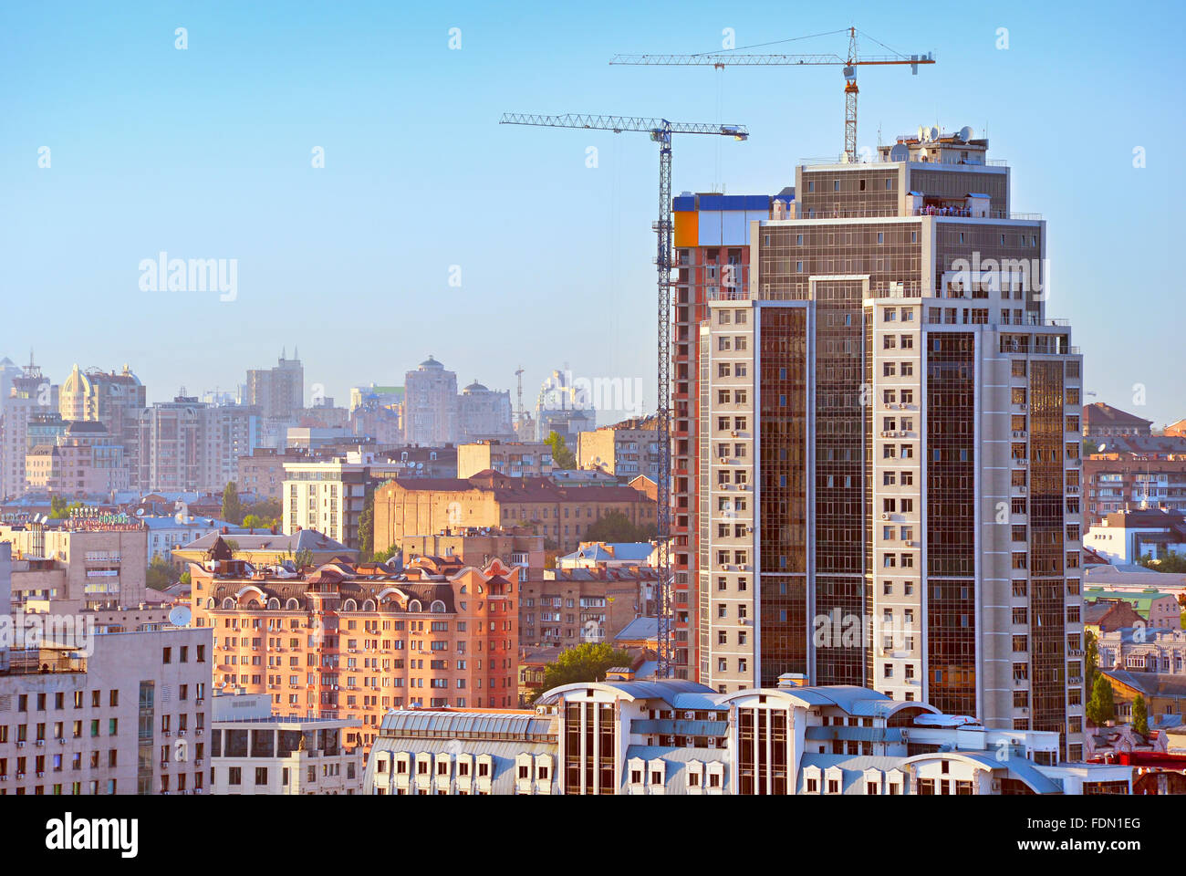 Construction cranes and modern skyscraper in downtown of Kiev, Ukraine ...