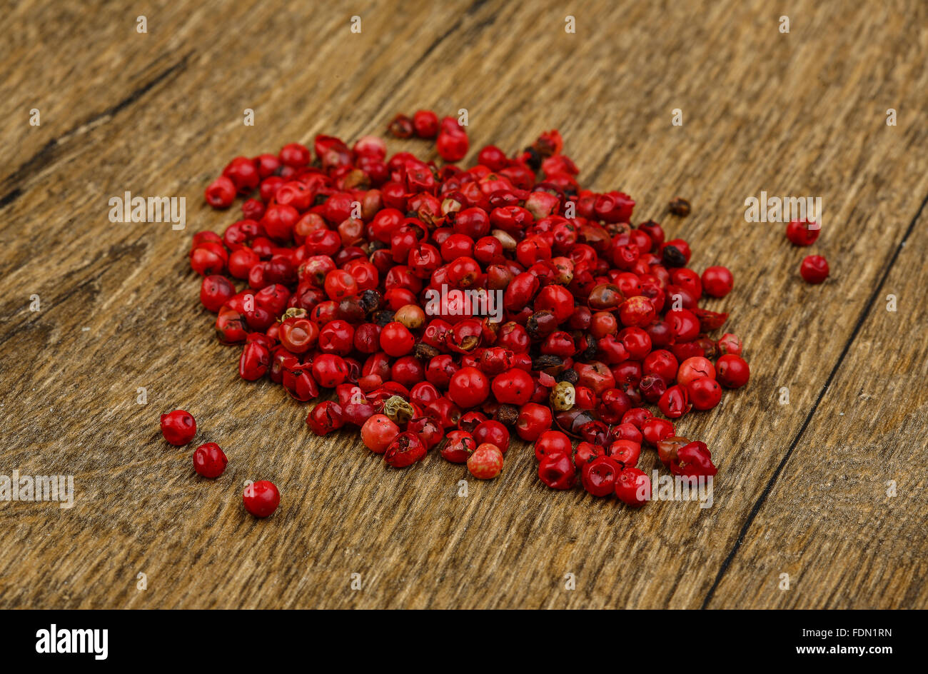 Dry Rose pepper corn on the wood background Stock Photo - Alamy