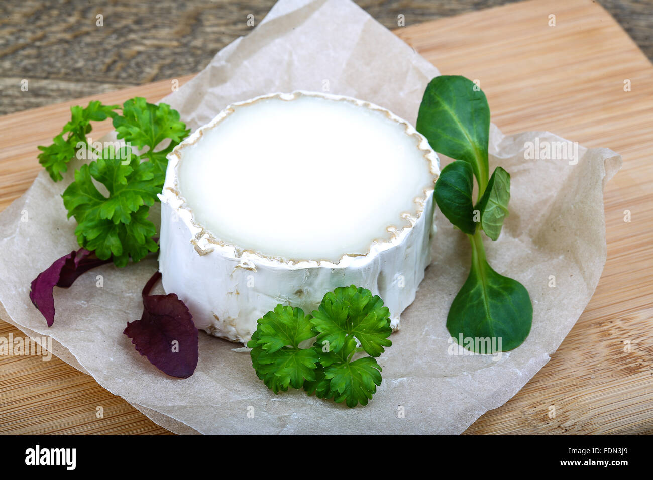 Goat cheese with white mold served parsley leaves Stock Photo - Alamy