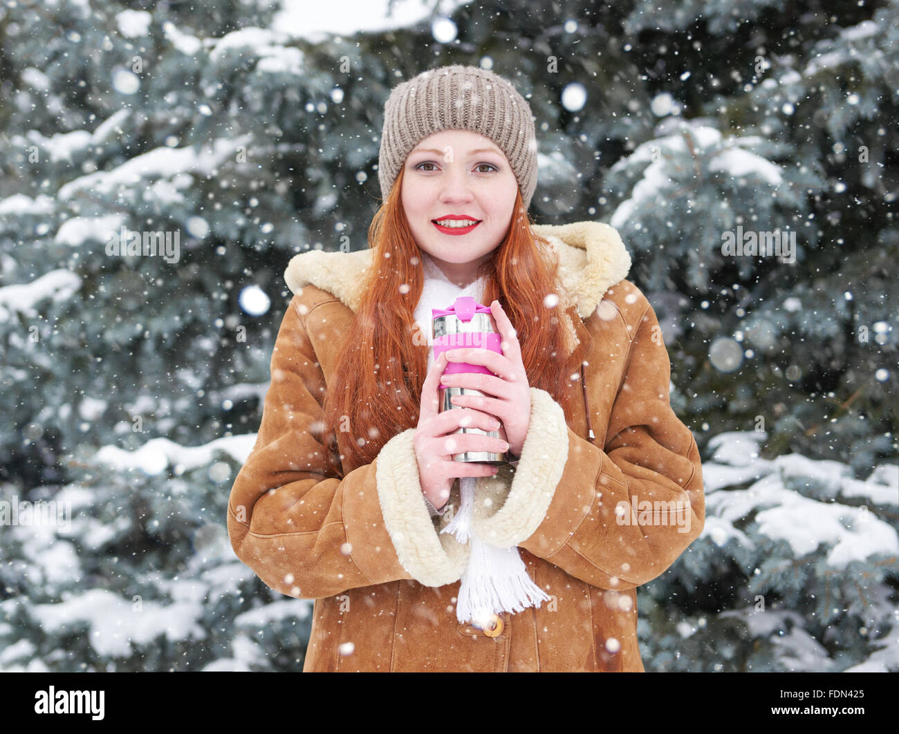 Girl drink tea in winter forest at day. Fir trees with snow Stock Photo ...