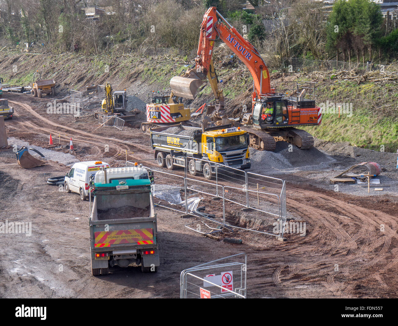 Digger loading a truck up with soil for a new road layout Stock Photo ...