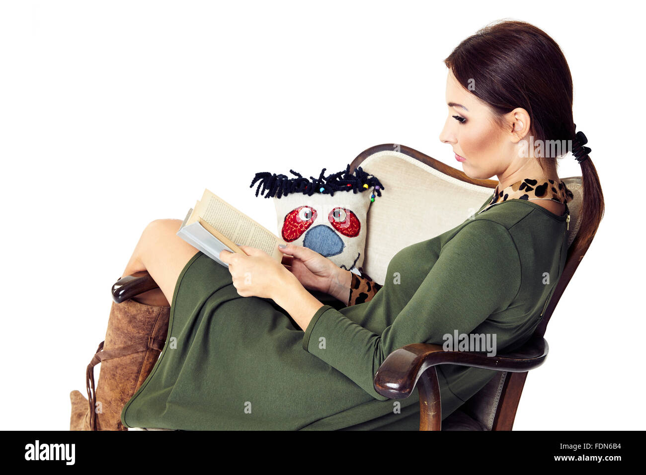 Studio shot of pensive woman reading a book. Isolated on white ...