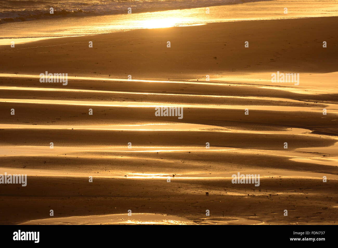 Sunset and ripple patterns on the sand at Bournemouth, UK, beach Stock ...
