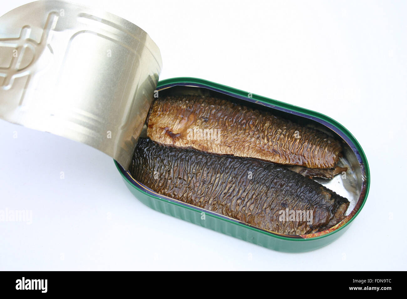Open can of fish on a white background Stock Photo - Alamy
