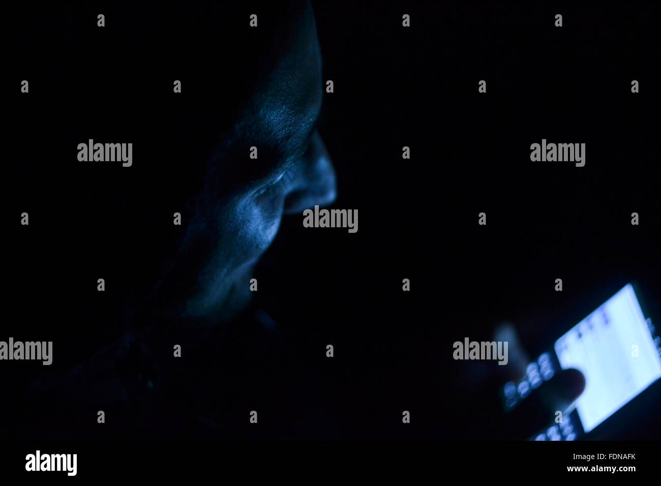 Man texting at night in dark Stock Photo - Alamy
