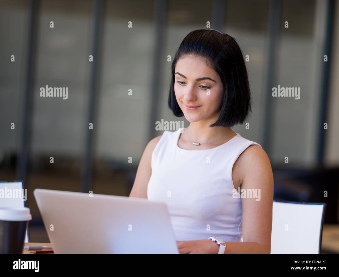 Young busines woman sitting and working with notebook Stock Photo - Alamy