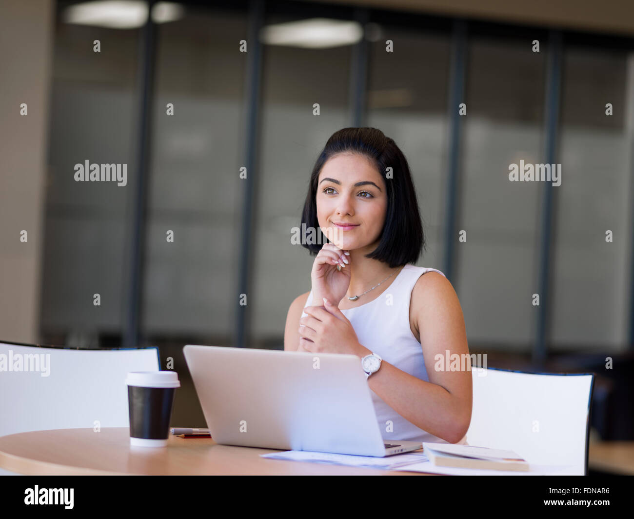 Young busines woman sitting and working with notebook Stock Photo - Alamy