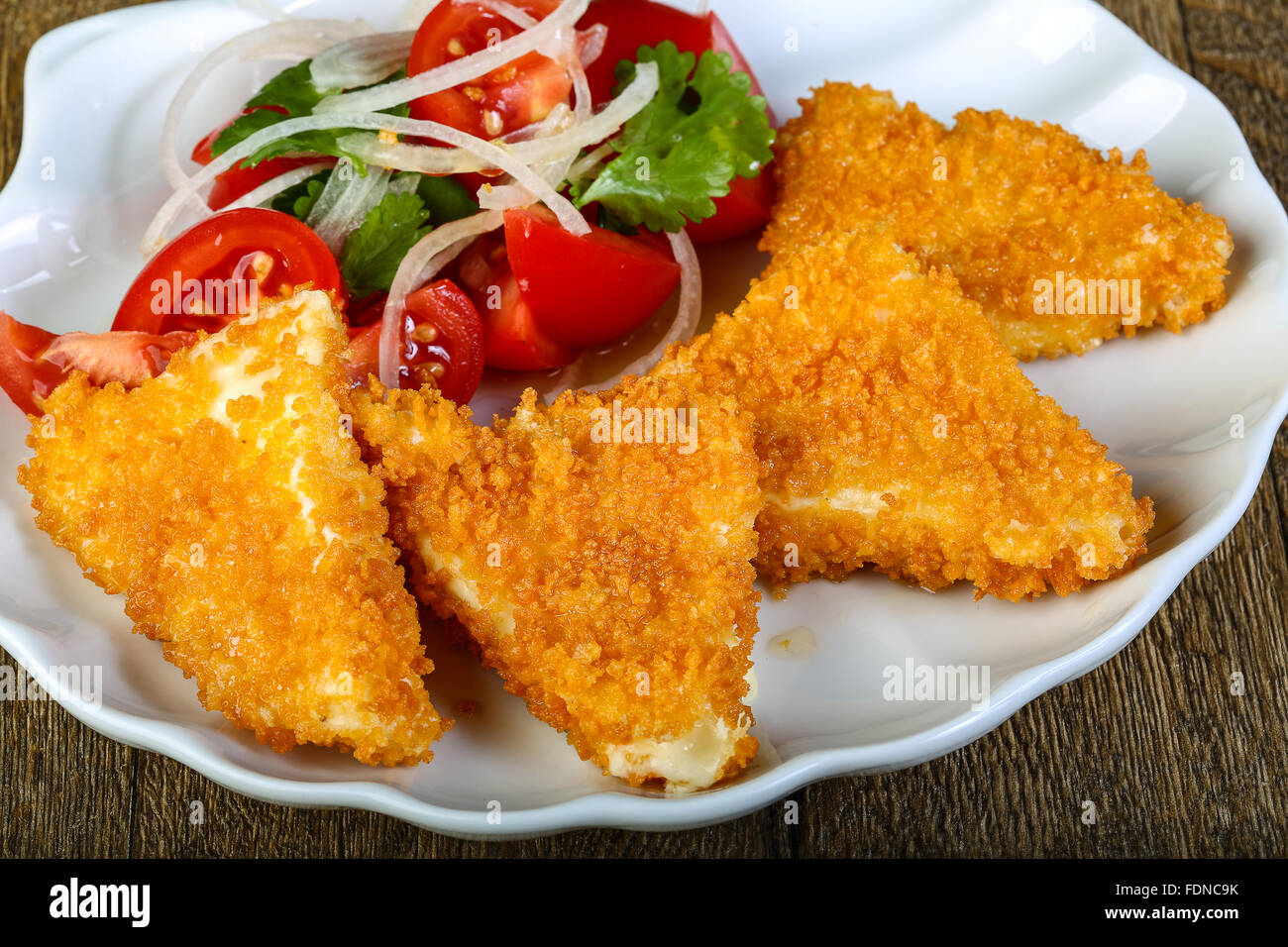 Fried cheese triangles with vegetables salad Stock Photo - Alamy