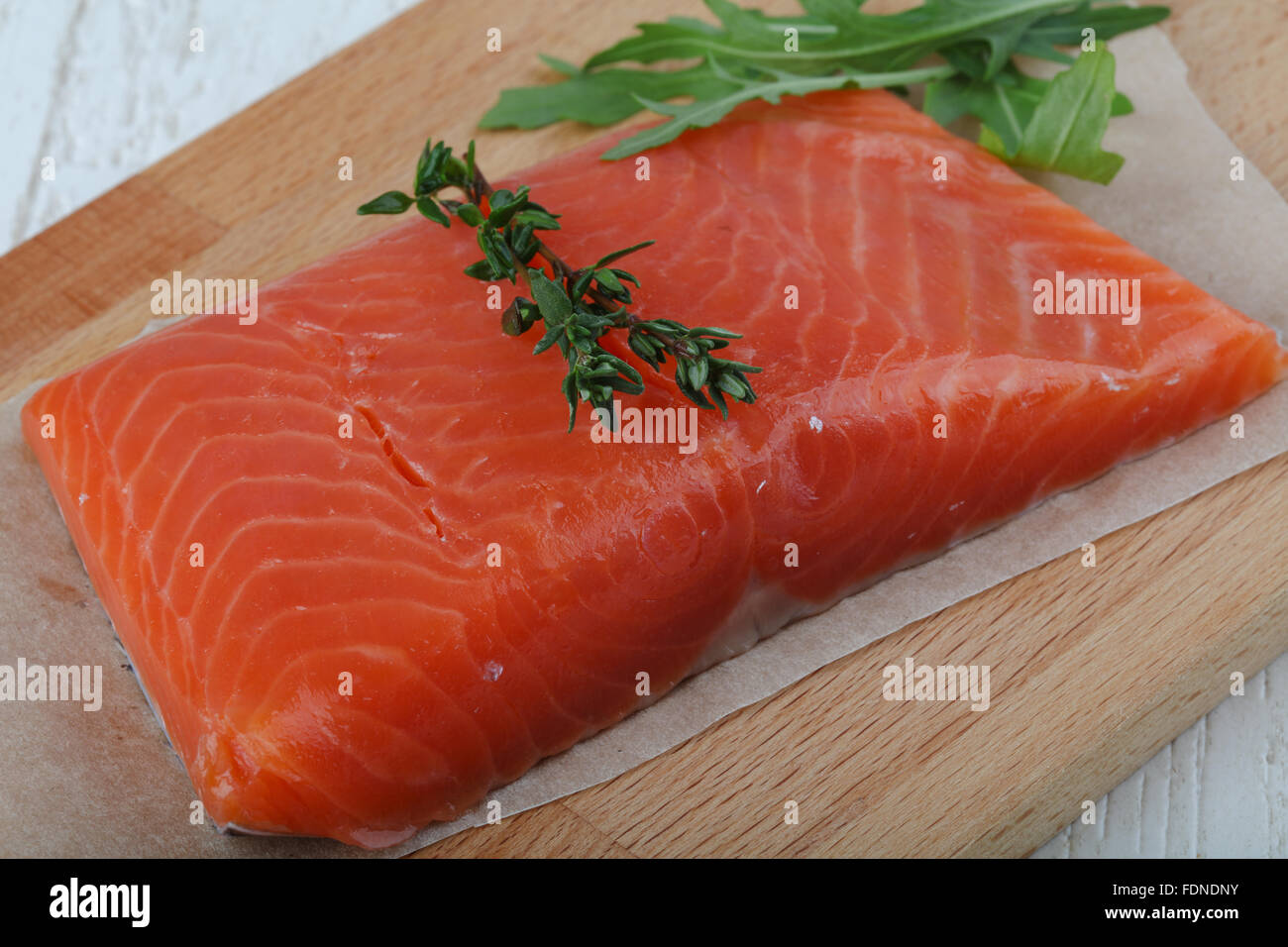 Salted salmon with thyme leaves on the wood background Stock Photo - Alamy