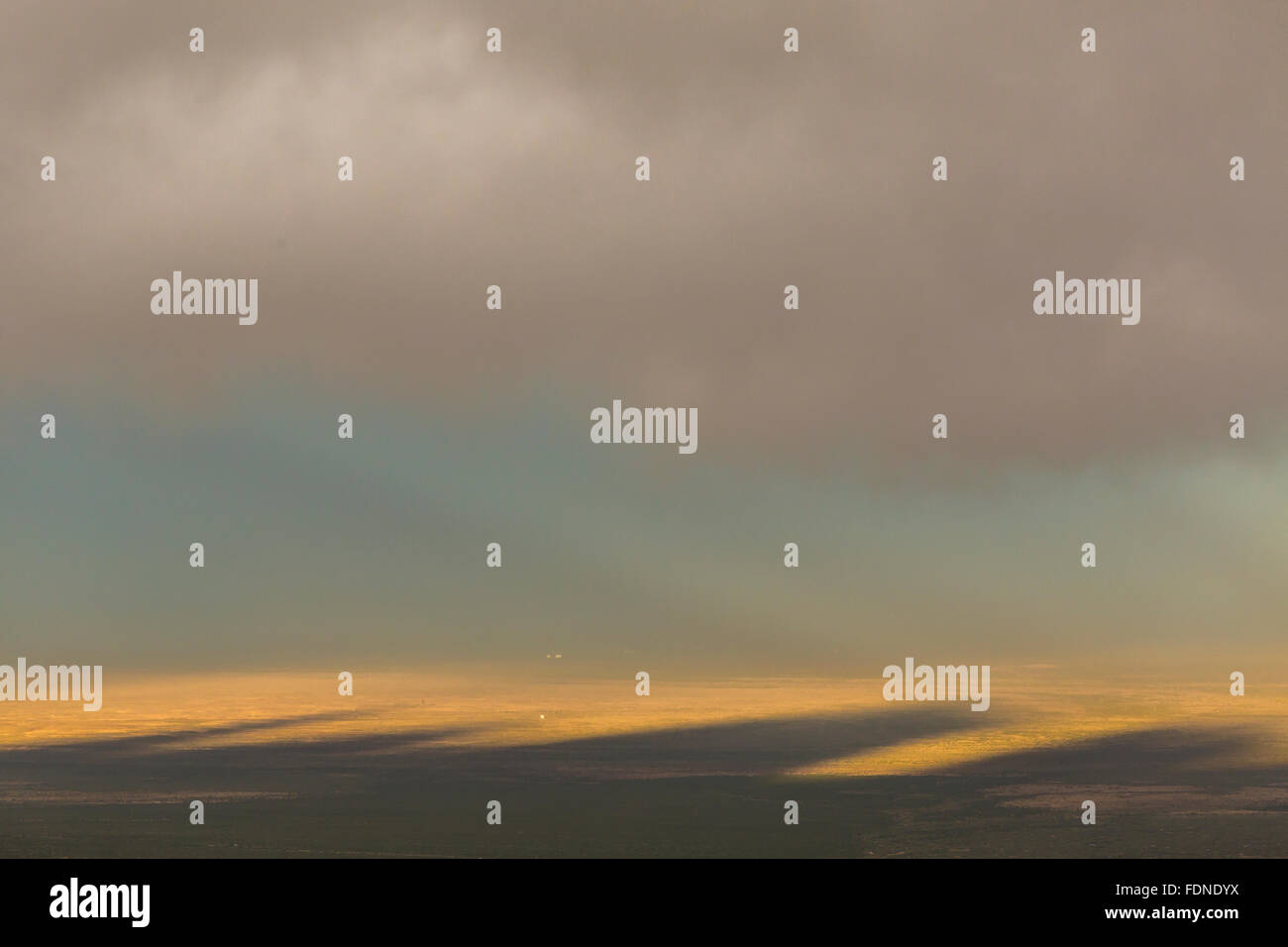 Storm clouds with morning shadows cast by the Organ Mountains over the ...
