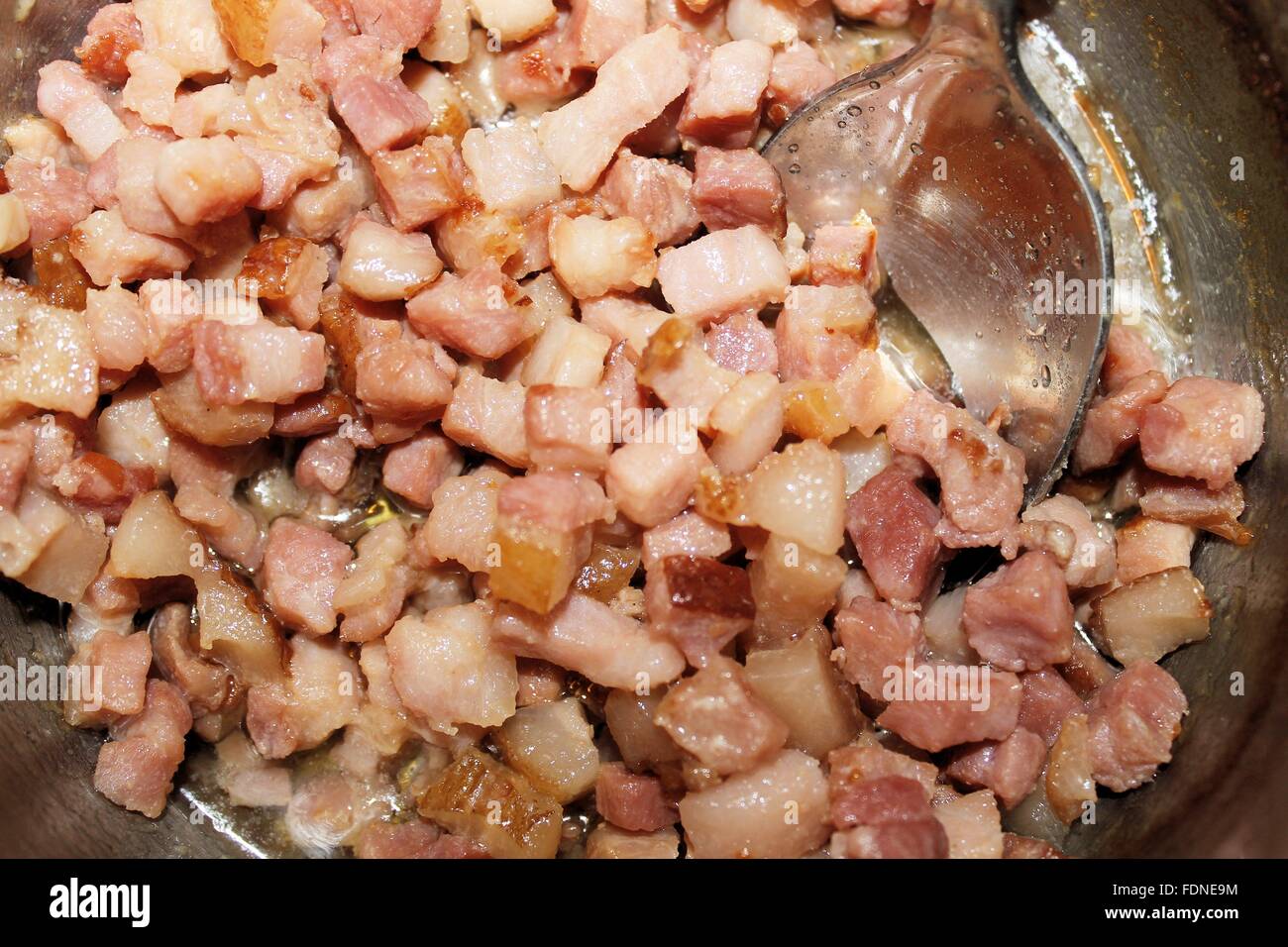 diced bacon frying in a pan with oil Stock Photo - Alamy