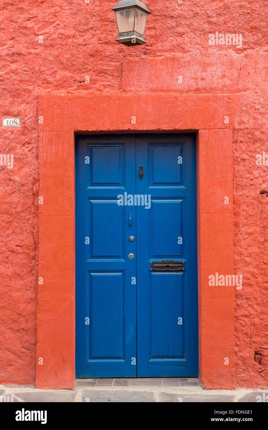 A traditional hacienda style painted wooden door on a historic home in ...