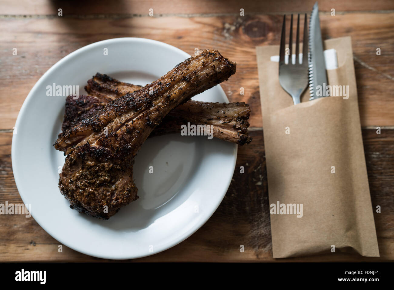Two lamb chops on a plate below Stock Photo - Alamy