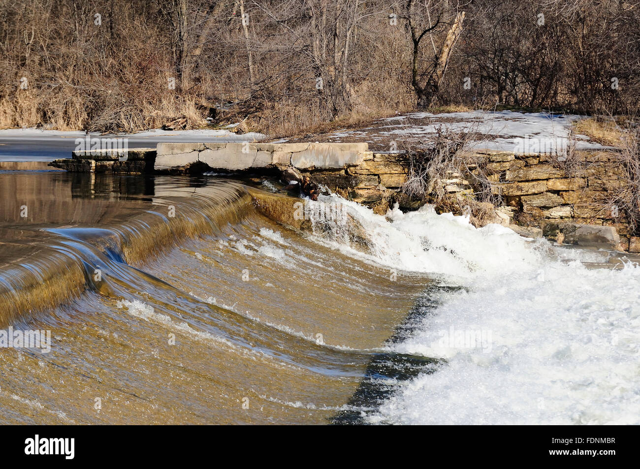 Water flowing over dam on river Stock Photo - Alamy