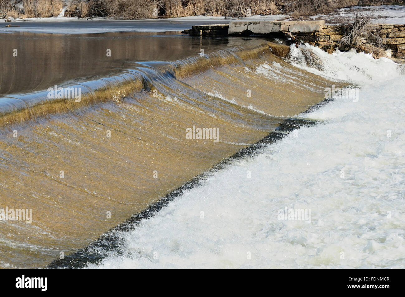 Water flowing over dam on river Stock Photo - Alamy